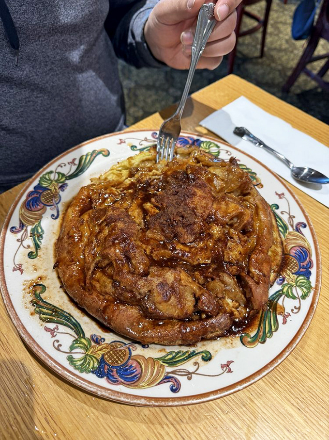 The German apple pancake arrives like breakfast performance art—a gravity-defying puff of cinnamon-scented glory that's worth the 20-minute wait.