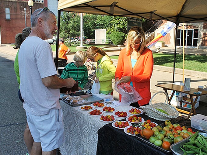 Fresh tomatoes at Guthrie's farmers market—where conversations with strangers about heirloom varieties are as nourishing as the produce itself.
