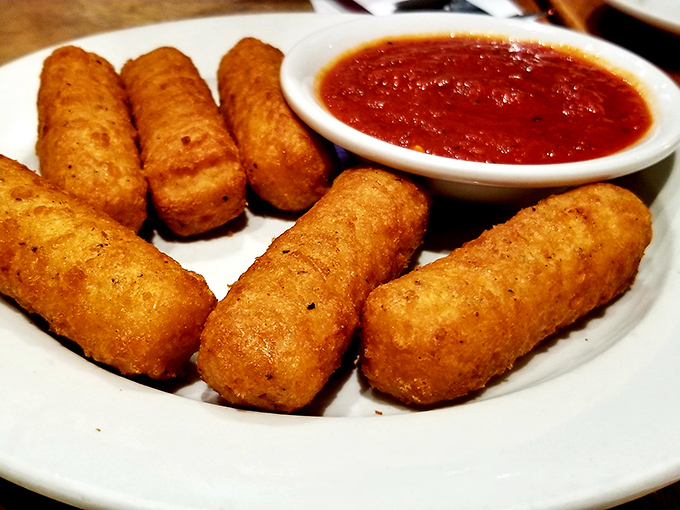 Mozzarella sticks: the universal language of appetizer joy. Crispy golden exterior, molten cheese interior, and marinara for dunking—perfection achieved.