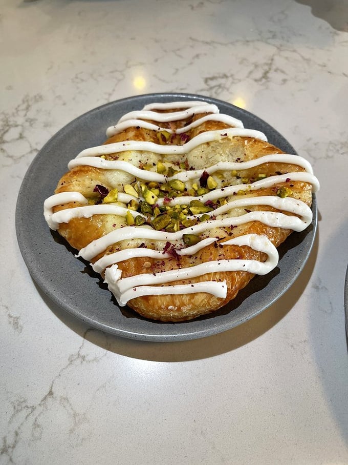 Not just a pastry—a golden, flaky landscape drizzled with cream and studded with pistachios like edible emeralds.