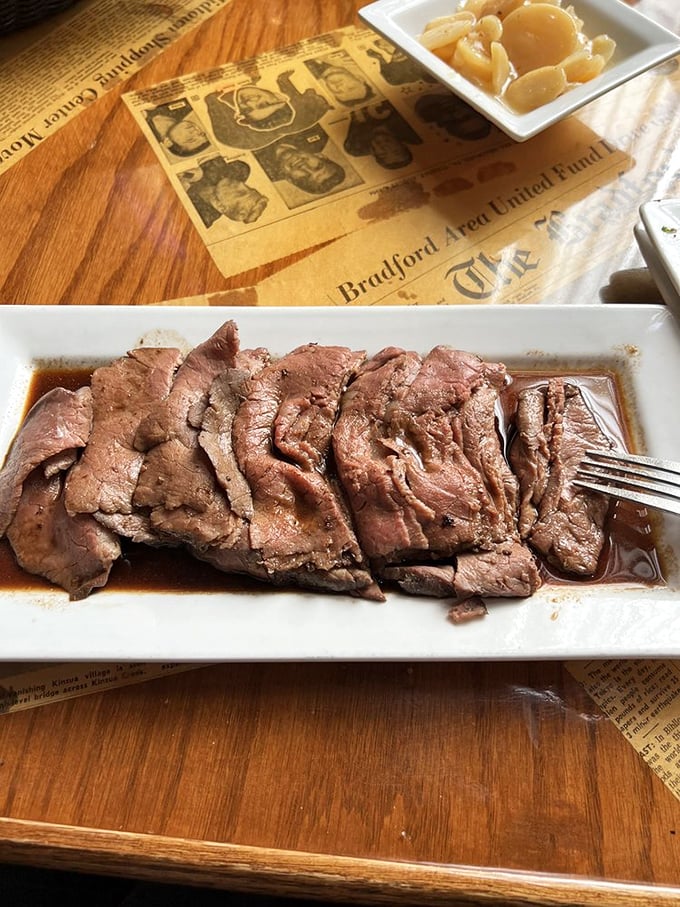 Served on vintage newspaper-covered tables, this prime rib tells a story more compelling than anything printed beneath it. 