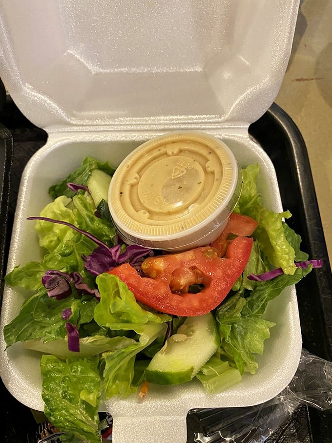 Even the side salad gets respect here – a fresh, crisp counterpoint to all that smoky richness. Balance in all things, especially barbecue.