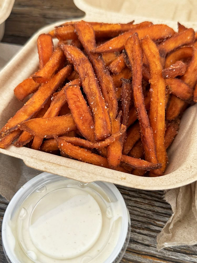 Sweet potato fries with dipping sauce—the supporting actor that sometimes steals the scene from the burger star.