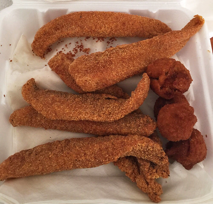 Crispy fish fillets arranged like golden treasure, accompanied by hush puppies that could convert even the most devoted bread basket enthusiast.