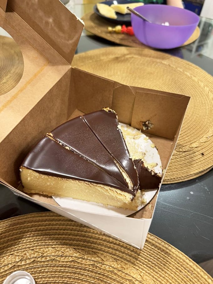 That chocolate-topped slice isn't just dessert—it's an event. The kind that makes you close your eyes and forget your table manners.