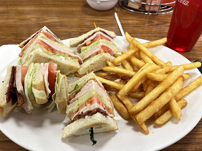 The club sandwich—architectural marvel of the diner world—stacked higher than a high-roller's chips and twice as satisfying when you hit the jackpot.