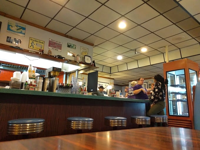 The counter—where solo diners become regulars, secrets are shared with strangers, and breakfast tastes better for mysterious reasons.