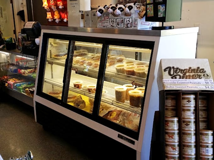 The dessert case—where willpower goes to surrender. Each pie and cake patiently waits its turn to ruin your best intentions.