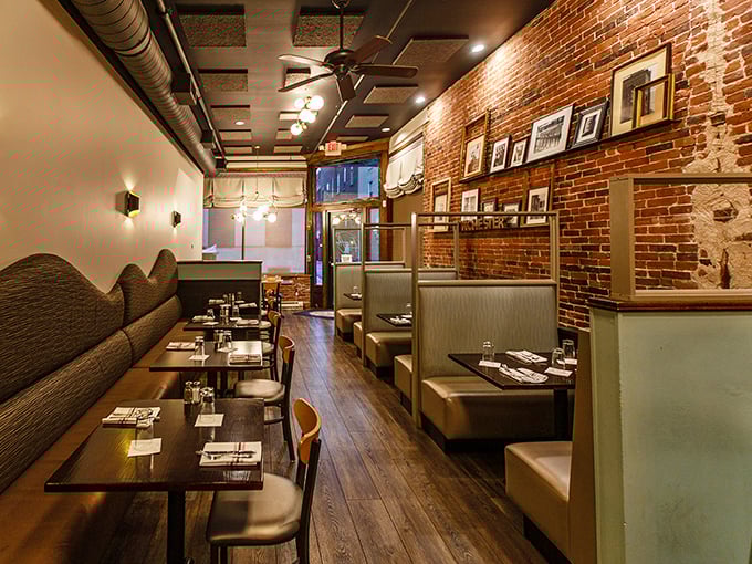 The dining room whispers "stay awhile" with its exposed brick, golden lighting, and booths that cradle you like a warm New England hug.
