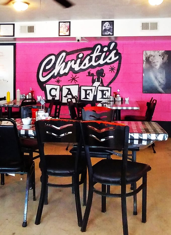 The vibrant pink logo wall isn't just decoration—it's a mission statement: We're bold, we're proud, and we're serious about comfort food.