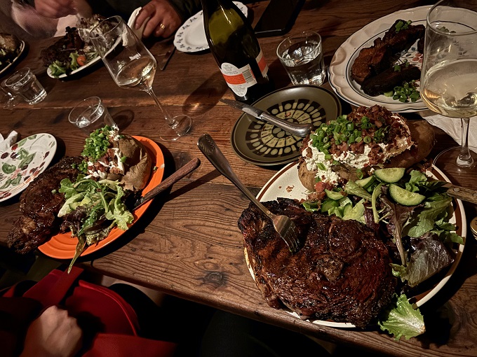 A table spread that turns dinner into an event. Notice how nobody's looking at their phones? That's the power of proper steak.