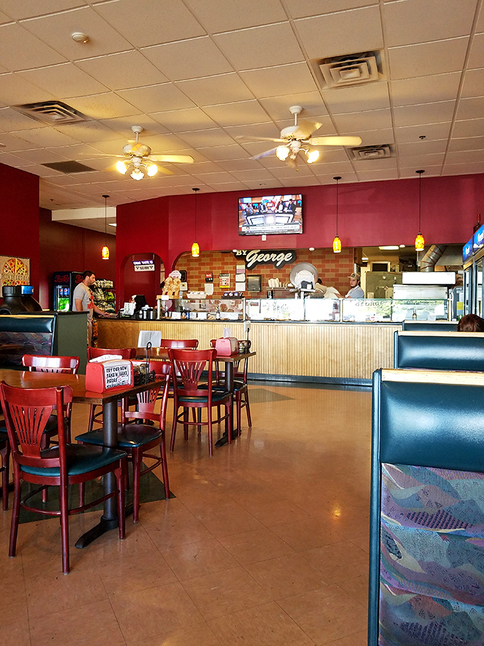 Pizza by George's warm interior feels like the living room of that friend who always feeds you too well and sends you home happy.