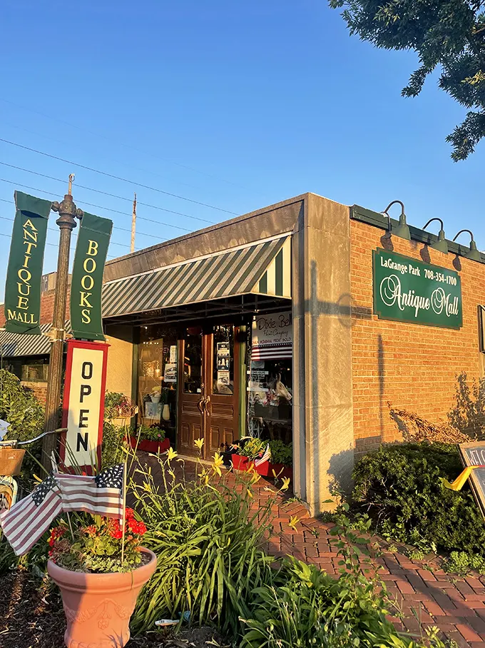 A treasure hunter's first glimpse of paradise. The brick storefront with its vibrant garden welcomes visitors like a time portal disguised as a neighborhood shop.
