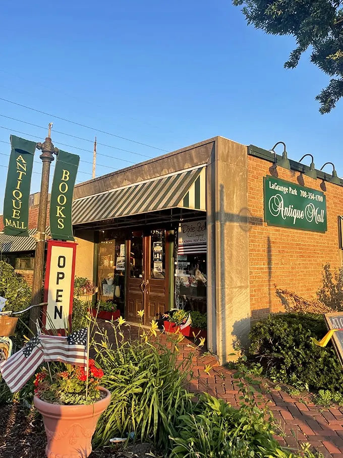 A treasure hunter's first glimpse of paradise. The brick storefront with its vibrant garden welcomes visitors like a time portal disguised as a neighborhood shop.