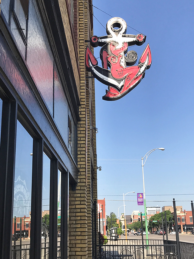 The iconic red anchor sign glows like a beacon against the historic yellow brick, guiding hungry souls to sandwich salvation.