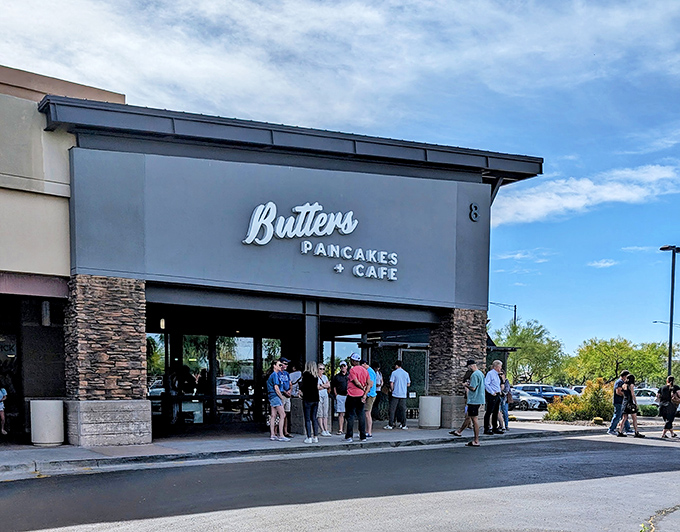 The stone-accented facade of Butters Pancakes & Cafe doesn't just welcome you—it practically issues a breakfast challenge to the line of eager patrons.