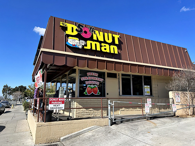 The humble roadside stand with its iconic yellow sign sits against the San Gabriel Mountains like a sweet oasis on Route 66.