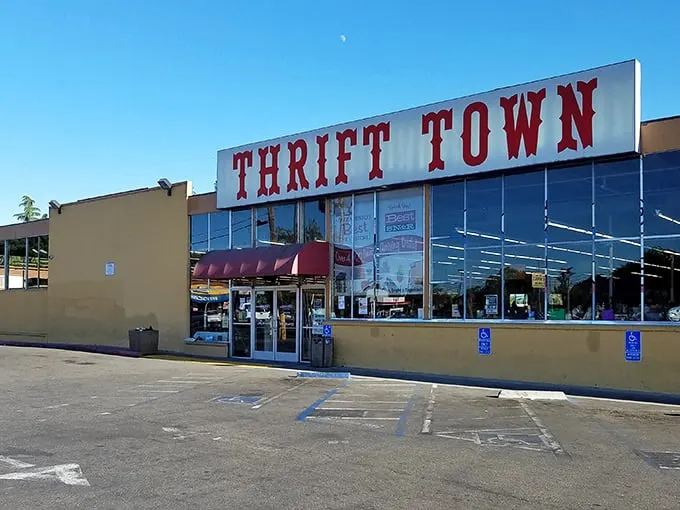 The iconic red Thrift Town sign beckons like a lighthouse for bargain hunters. Sacramento's temple of thrift stands ready for treasure seekers of all budgets.