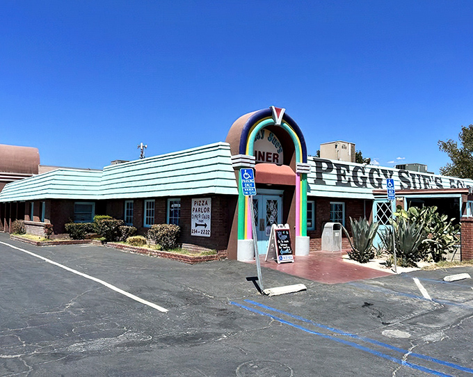 The rainbow-colored archway of Peggy Sue's beckons like a time portal in the desert. This isn't just a pit stop—it's a destination.