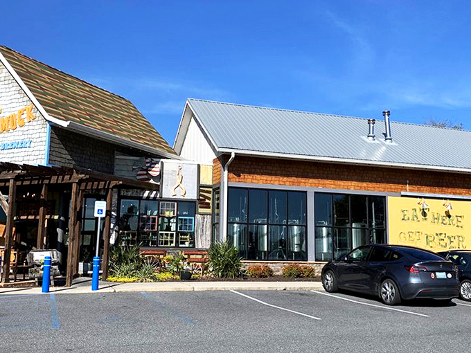Sunshine, blue skies, and that inviting coastal architecture – the Crooked Hammock's exterior practically whispers, "Your afternoon plans? They're right here."