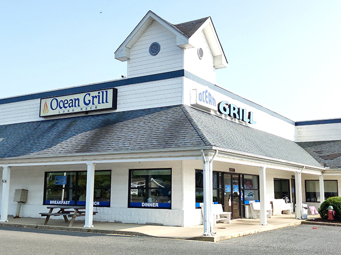 The white clapboard exterior of Ocean Grill stands like a beacon of comfort food promise. Those nautical round windows aren't just for show—they're portals to flavor town.