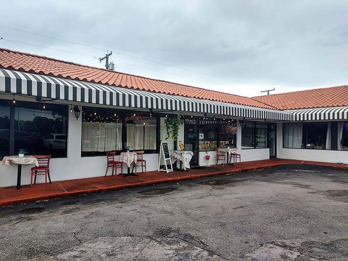 The black and white striped awning and bright red door of La Fresa Francesa isn't just charming—it's like Paris decided to vacation in Hialeah and never left.