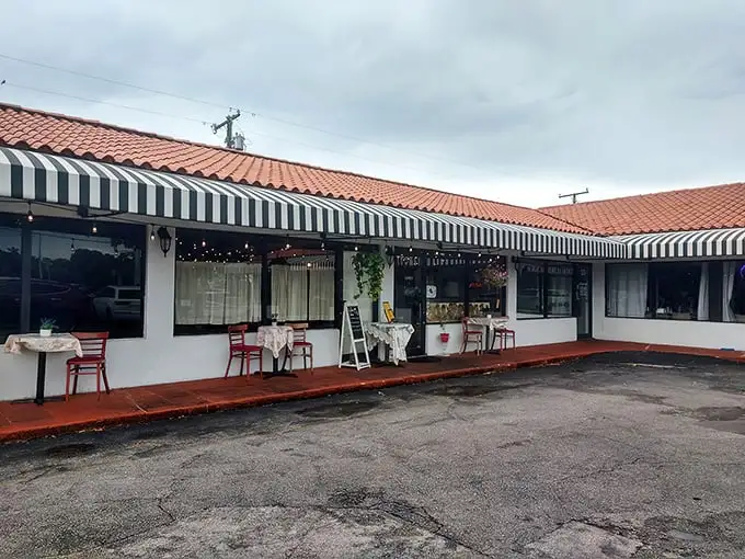 The black and white striped awning and bright red door of La Fresa Francesa isn't just charming—it's like Paris decided to vacation in Hialeah and never left.