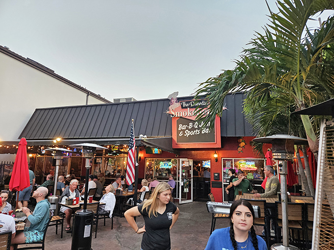 The Dunedin Smokehouse's vibrant exterior beckons like a barbecue siren, with its inviting patio where locals gather to worship at the altar of smoked meats.
