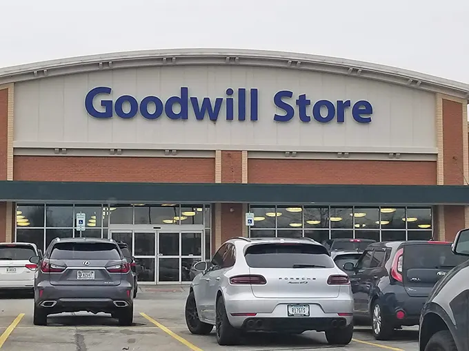 The Fishers Goodwill welcomes bargain hunters with its distinctive curved roofline and bold blue signage—a cathedral of second-hand treasures awaiting discovery.