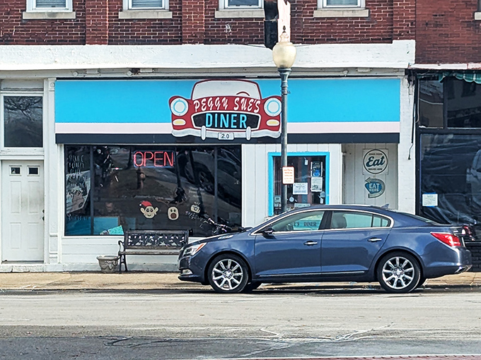 Welcome to Peggy Sue's, where the blue awning beckons like a retro beacon of breakfast bliss. Step inside and prepare for a time-warp to deliciousness!