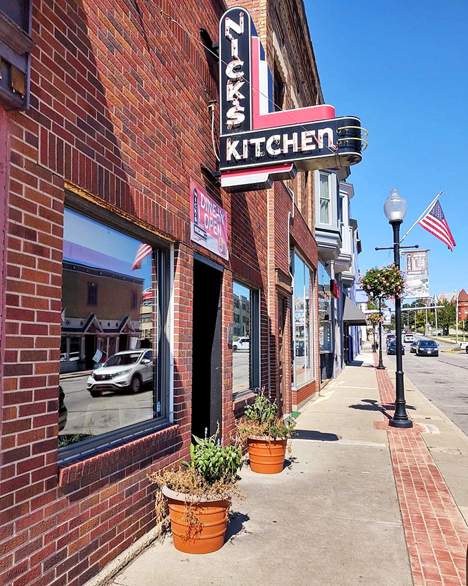 The iconic neon sign of Nick's Kitchen stands as a beacon of culinary history on Huntington's Jefferson Street. A century of tenderloin tradition lives behind this brick façade.