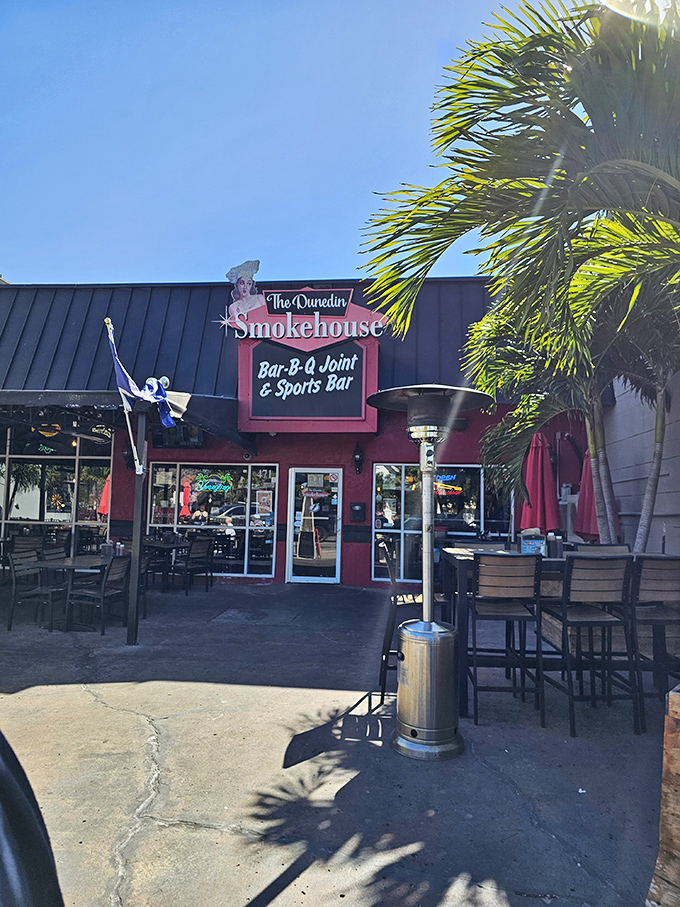 The Dunedin Smokehouse's vibrant exterior beckons like a barbecue siren, with its inviting patio where locals gather to worship at the altar of smoked meats.