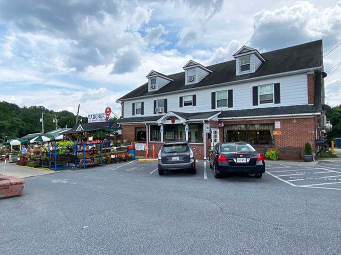The classic white colonial exterior of Baugher's stands like a beacon of comfort food promise against Maryland's blue skies.