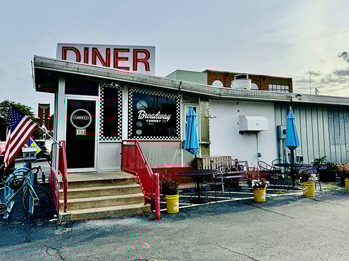 The classic checkerboard trim instantly telegraphs "authentic diner experience ahead" – a roadside beacon promising comfort food and conversation in equal measure. 