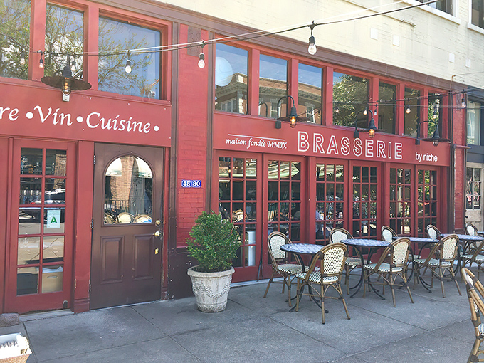 The burgundy façade beckons like a Parisian street corner transplanted to St. Louis, complete with those quintessential French bistro tables waiting for your arrival.