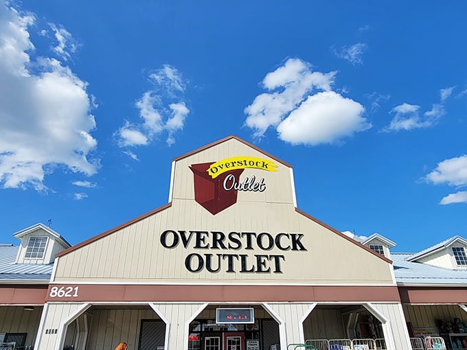 The unassuming barn-style exterior of Overstock Outlet promises treasure within—like finding a secret gold mine disguised as a humble homestead.