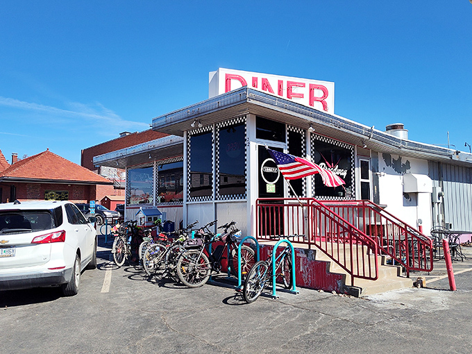 The classic checkerboard trim instantly telegraphs "authentic diner experience ahead" – a roadside beacon promising comfort food and conversation in equal measure. 