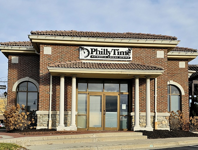 The stately brick exterior of Philly Time stands like a temple to sandwich perfection, complete with columns that say "We take our cheesesteaks seriously."