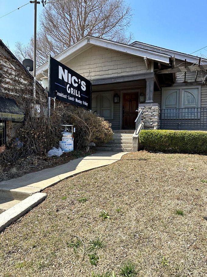 The unassuming exterior of Nic's Grill looks like any other house on the block—until you spot that sign promising burger nirvana inside.
