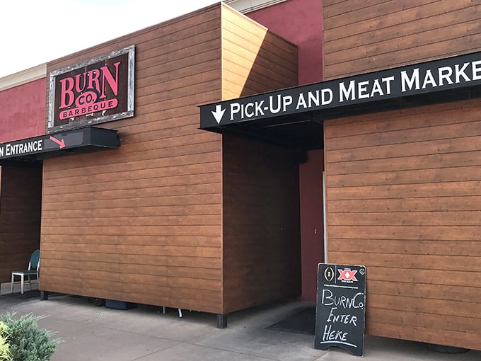 The wooden facade of barbecue paradise beckons with its bold red sign – a siren call to meat lovers that promises smoky delights within.