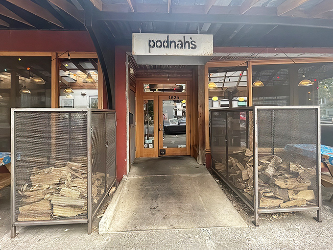 The entrance to barbecue nirvana, flanked by wood cages that aren't just decoration—they're the secret behind that intoxicating smoke aroma wafting through the neighborhood.