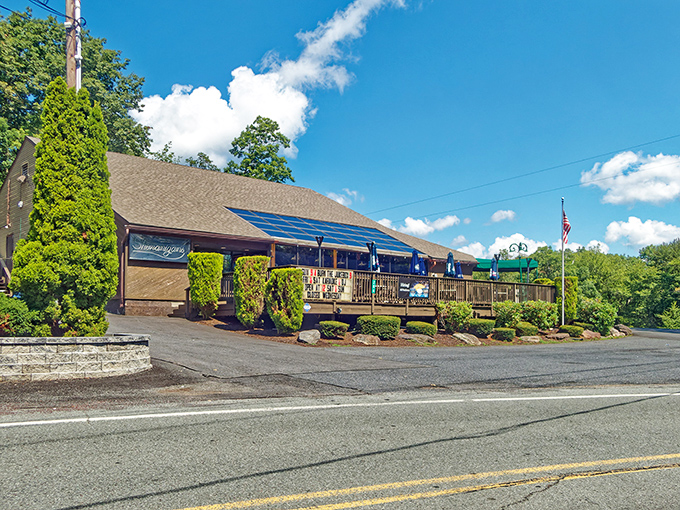 The forest parts to reveal culinary treasure – Louie's Prime Steak House stands proudly among the trees, its stone foundation and wooden charm beckoning hungry travelers.