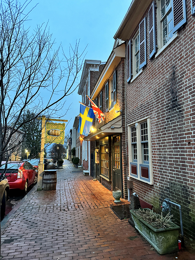 The historic façade of Jessop's Tavern welcomes you with colonial charm, international flags, and that wooden barrel that practically whispers, "Good times await inside."