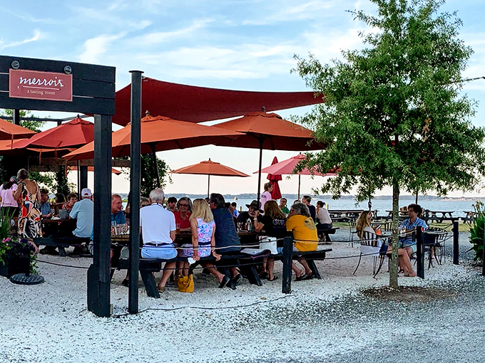 Merroir's unassuming exterior belies the culinary magic within. Those orange umbrellas aren't just for shade—they're beacons guiding seafood pilgrims to paradise.