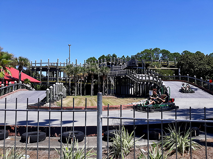 Racing around the bend, these go-karters experience that perfect moment when childhood joy meets adult competitive spirit. Those colorful tires aren't just for show—they're dream cushions for wannabe NASCAR stars.