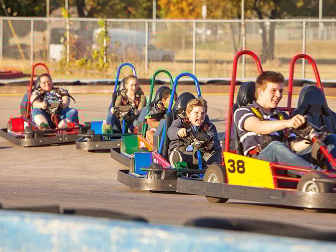 The winding track at Lokomotion beckons speed demons of all ages. Those red and blue barriers aren't just for show—they've caught many an overzealous driver with NASCAR dreams.