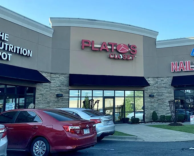 The tan façade and bold red signage of Plato's Closet beckons like a fashion oasis in the suburban retail landscape.