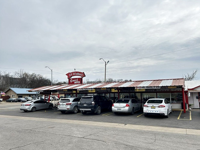 The classic red and white Buick parked outside isn't a prop—it's just another day at Ed Walker's, where time stands deliciously still.