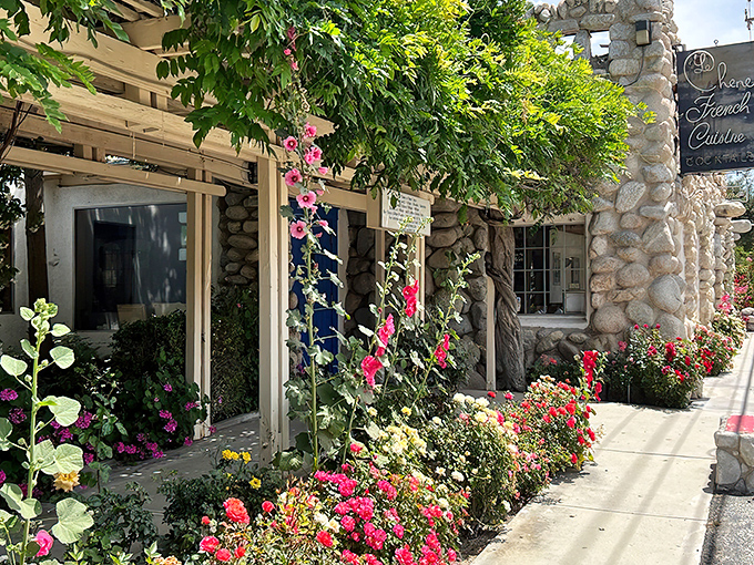 Stone by stone, this fairy tale façade promises culinary magic within. The blue door isn't just an entrance—it's a portal to France itself.