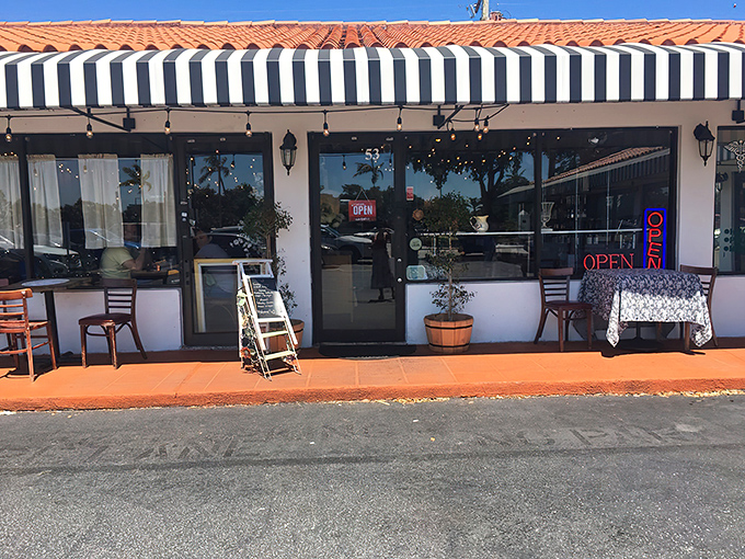 The black and white striped awning and bright red door of La Fresa Francesa isn't just charming—it's like Paris decided to vacation in Hialeah and never left.